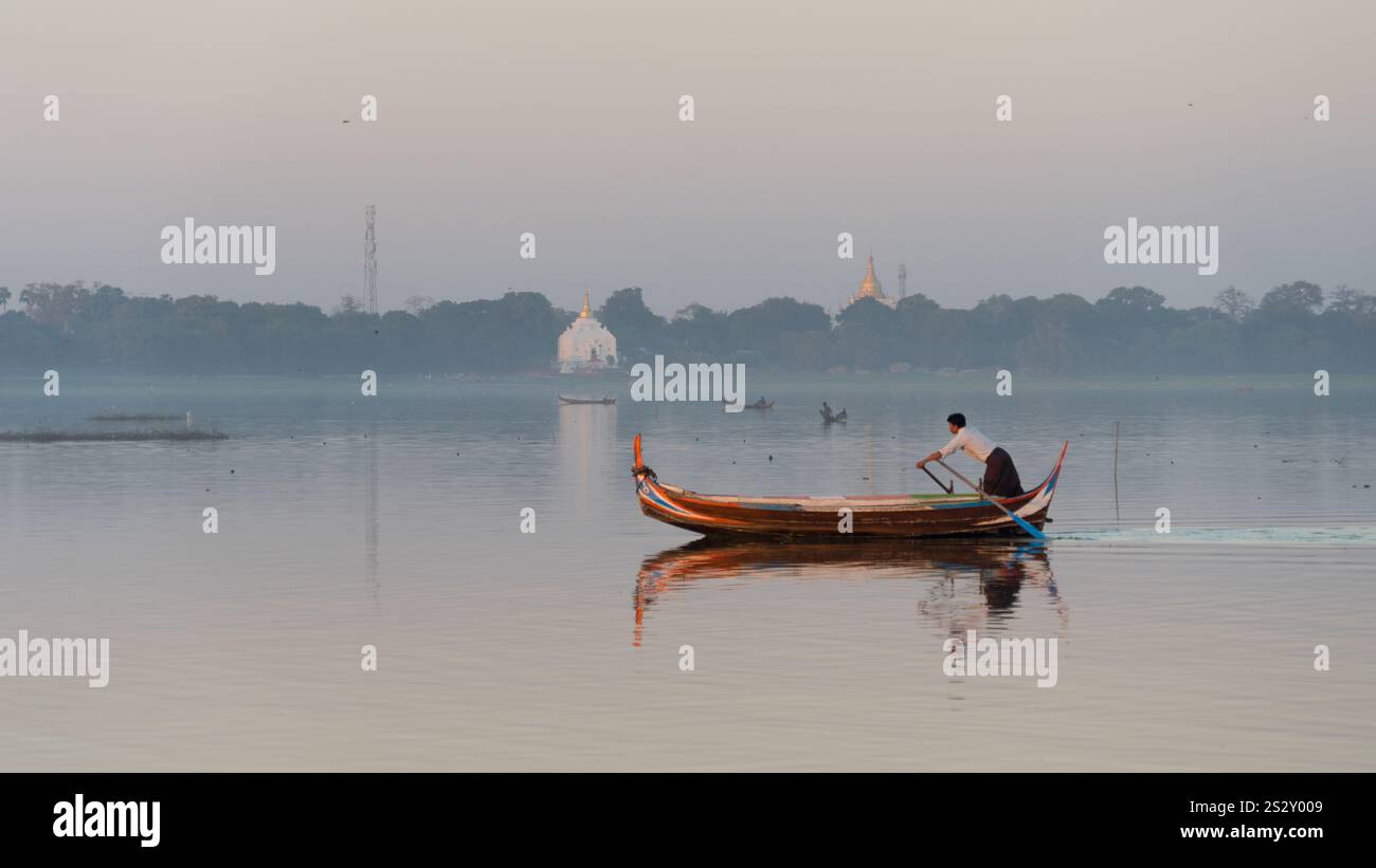 Man Rowing a Traditional Boat on a Serene Lake in Myanmar Stock Photo ...