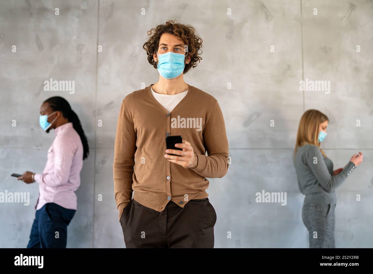 Social isolation at work, university. Young business people face masks ...