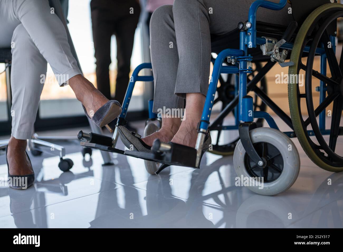 Diverse business colleagues collaborating. Woman in wheelchair working ...