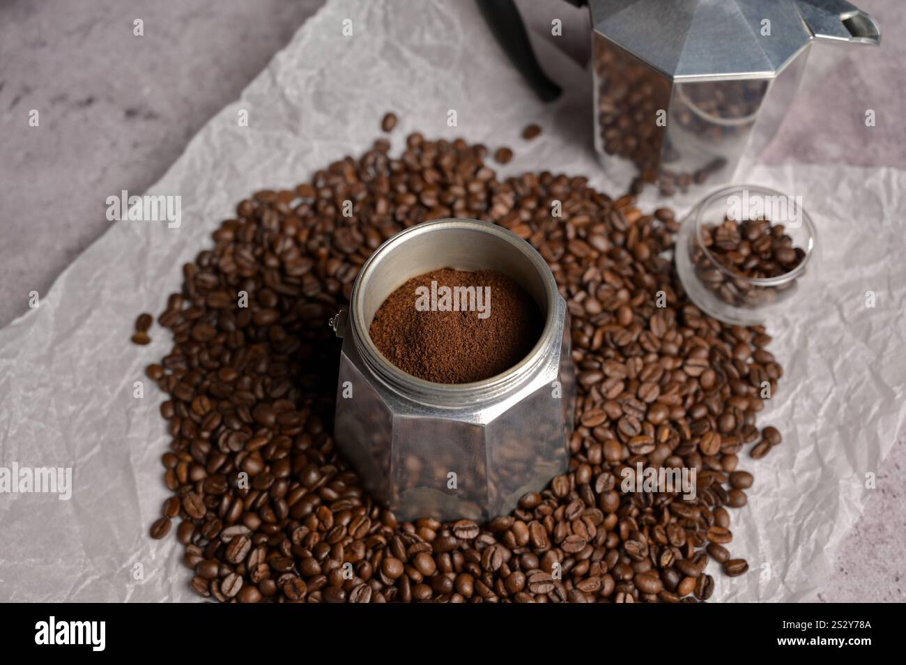 Ground coffee in a geyser coffee maker moka machine. Scattered fresh ...