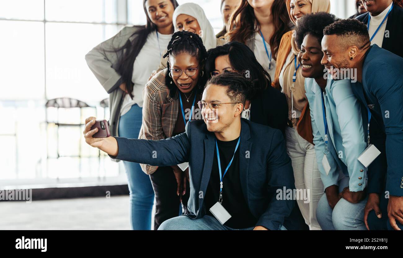 Business people gather for a joyful selfie after a workshop ...