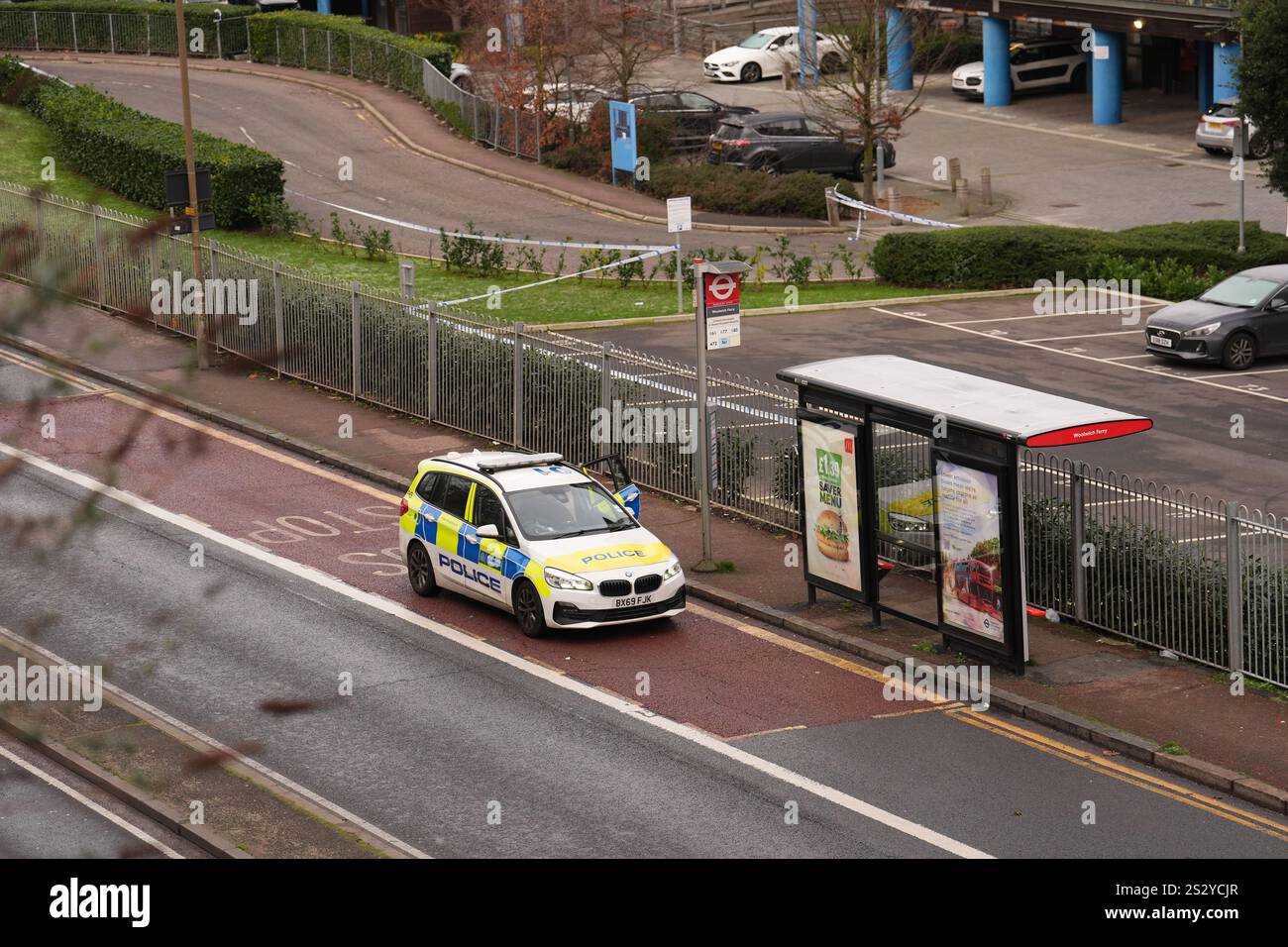 A police car next to a bus stop on Woolwich Church Road in Woolwich ...