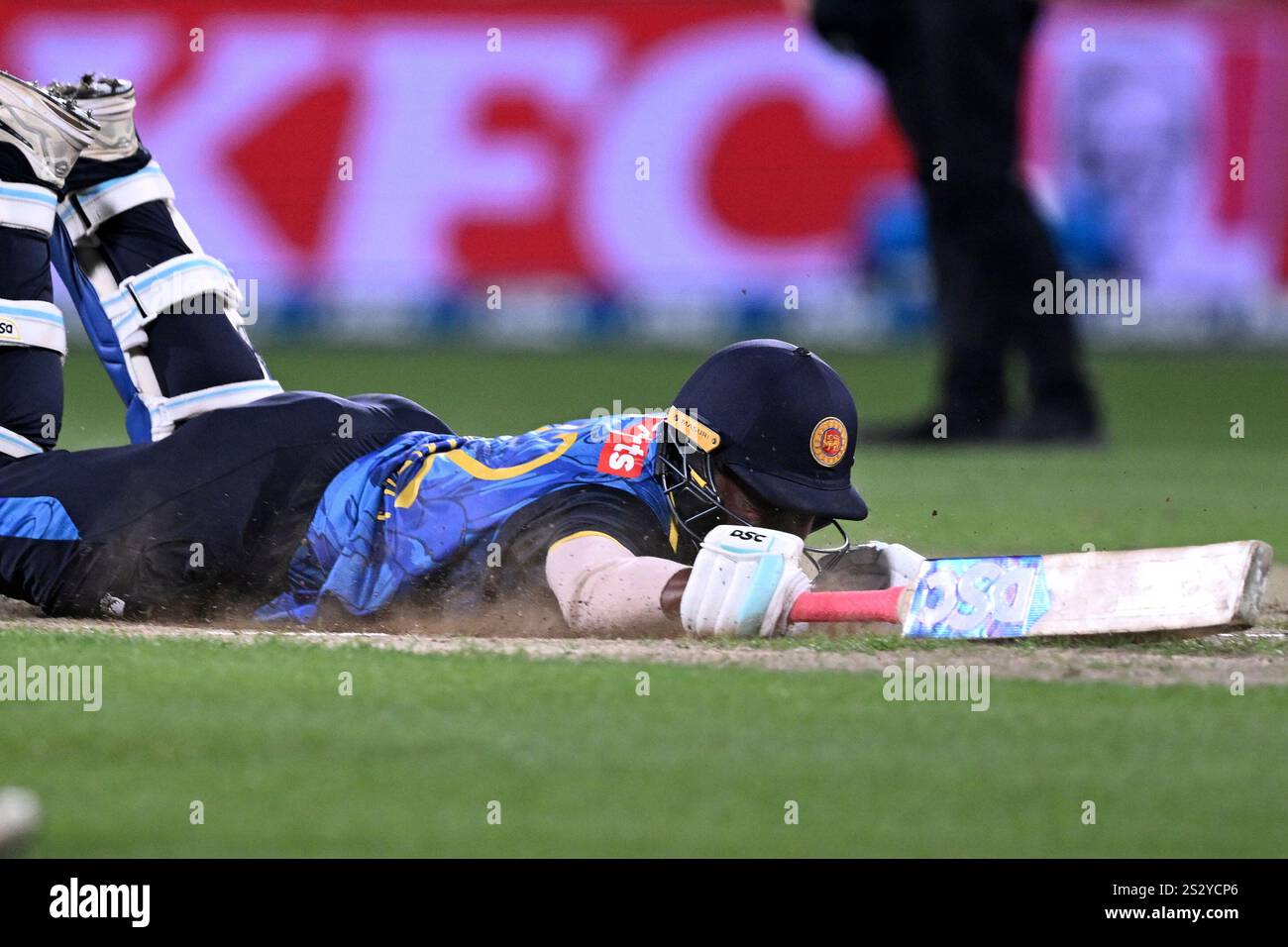 Sri Lanka's Sri Lanka's Chamidu Wickramasinghe slides on the ground as he is run out by New ...