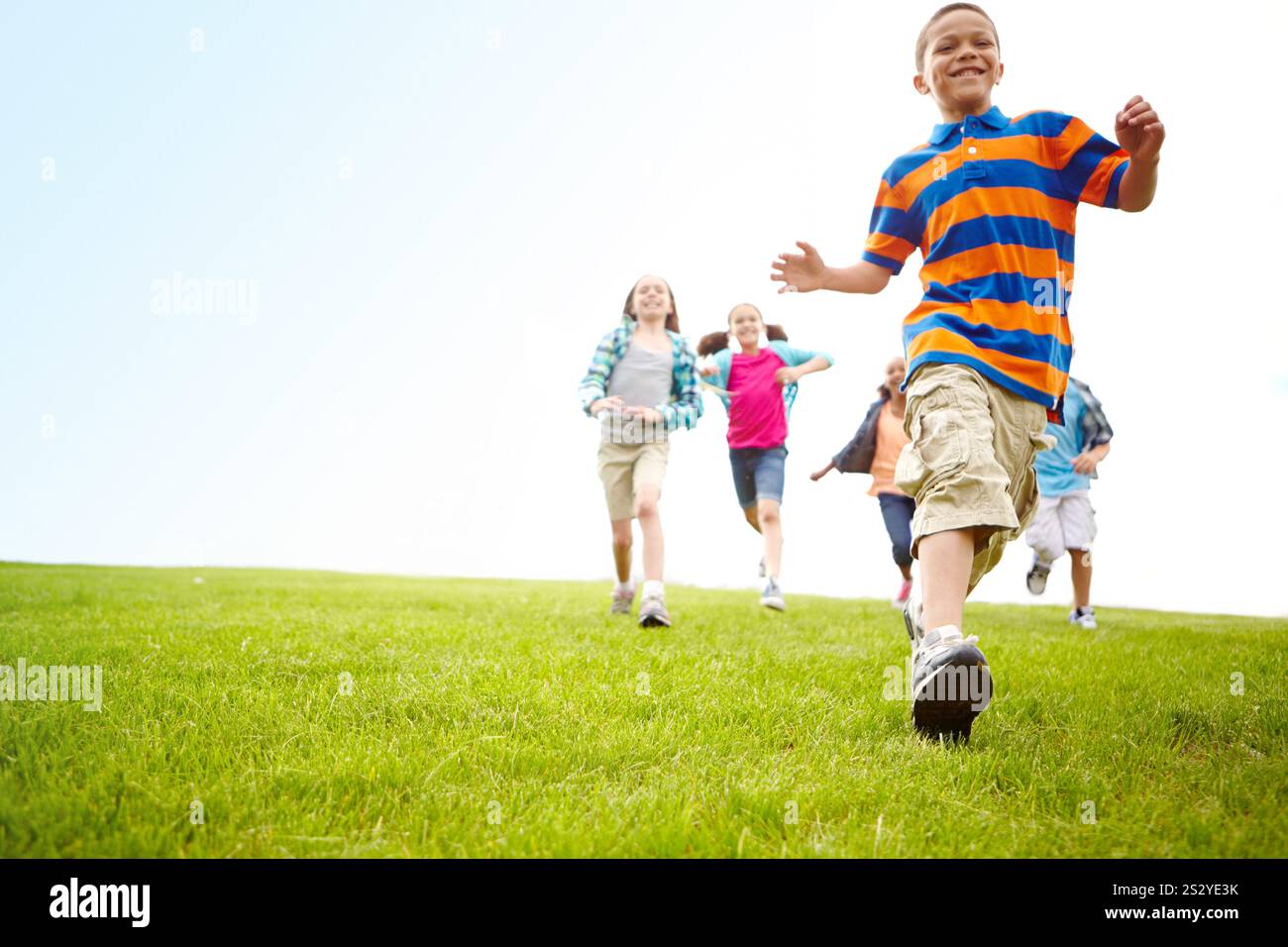 Adventure, running and group of children in field for outdoor games ...