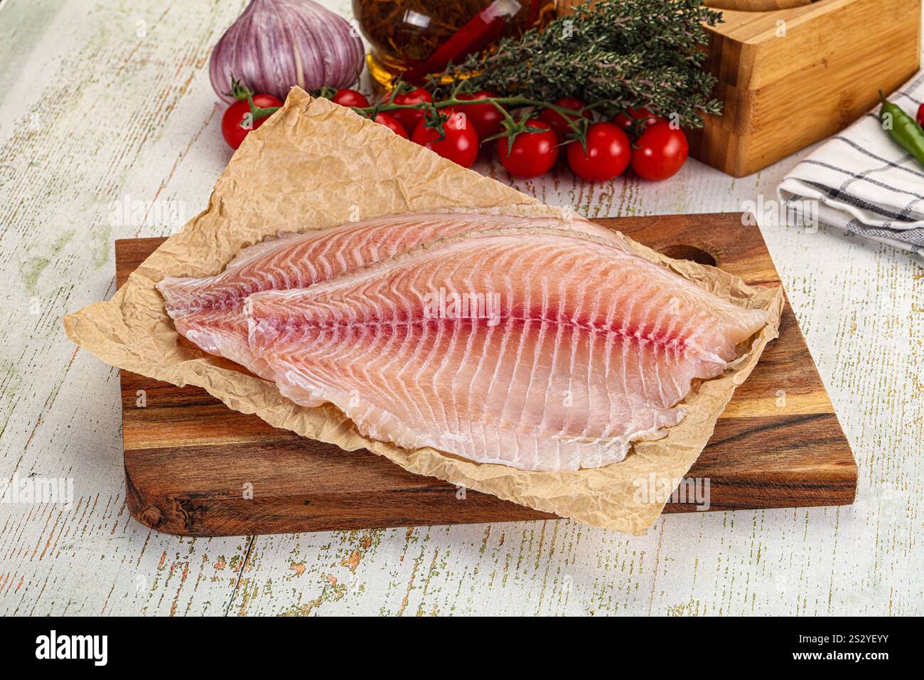Raw Tilapia fish fillet slice uncooked Stock Photo - Alamy