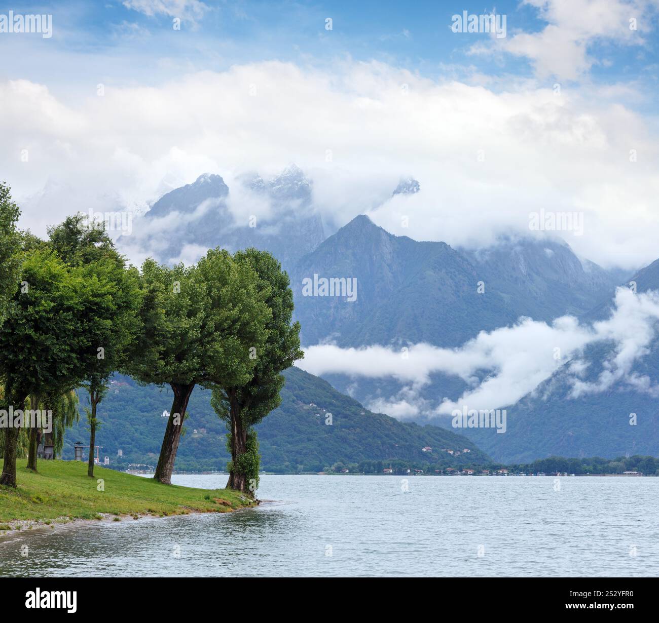 Lake Como (Italy) summer cloudy view with trees on shore Stock Photo ...