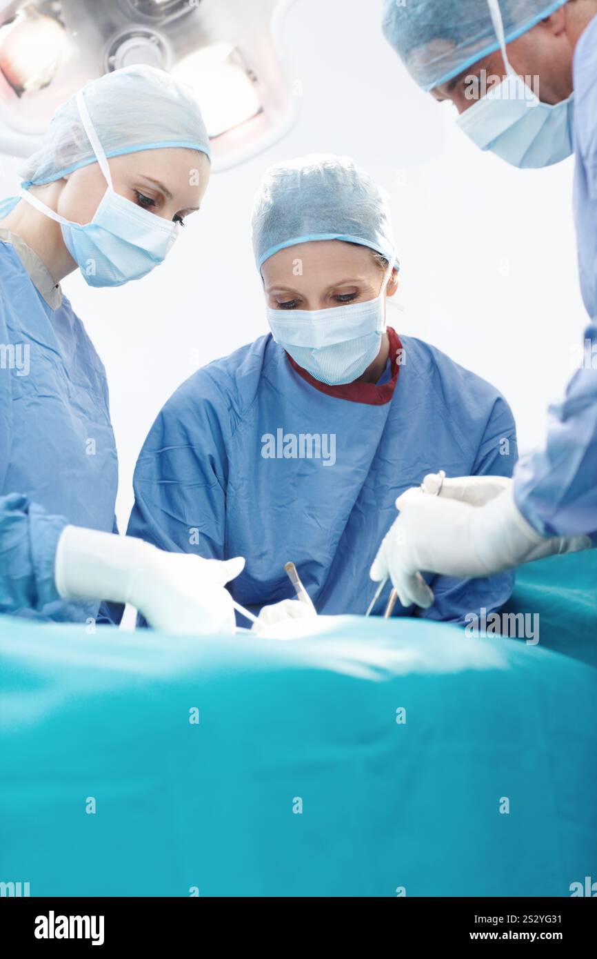Surgery, hospital and doctor procedure in operating room for patient ...