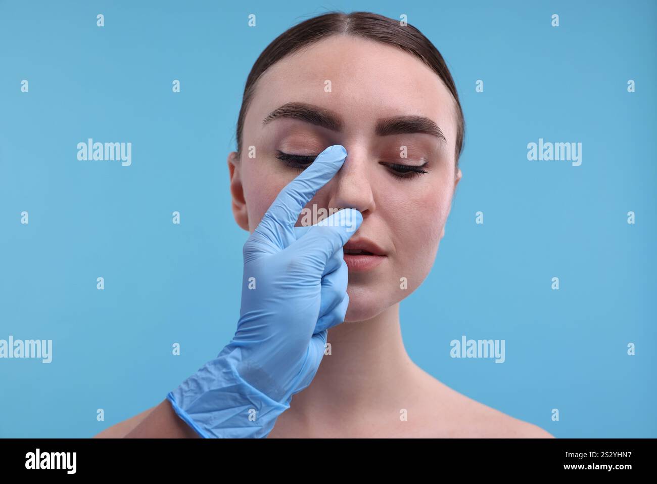 Doctor checking patient's nose before plastic surgery operation on ...