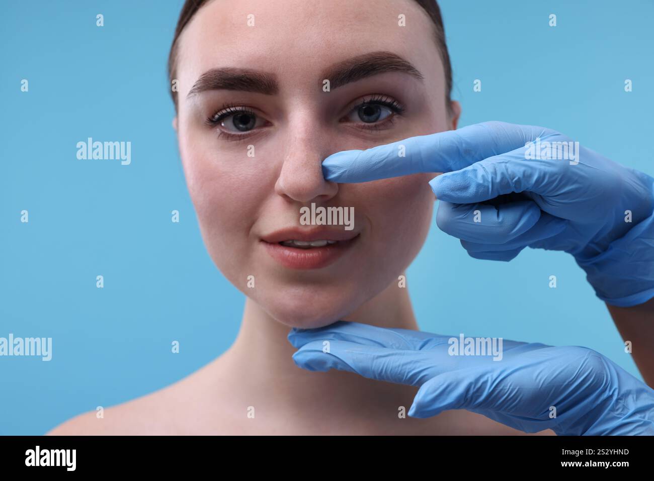 Doctor checking patient's nose before plastic surgery operation on ...