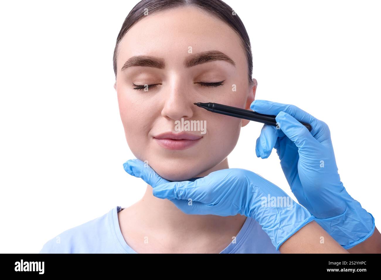 Doctor drawing marks on patient's nose for plastic surgery operation ...