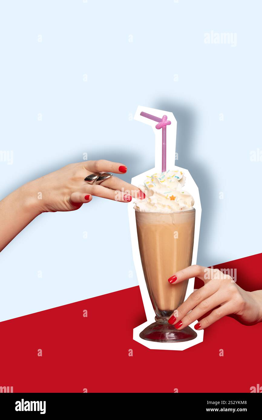 Female hand holding a cut-out milkshake cocktail with whipped cream and ...