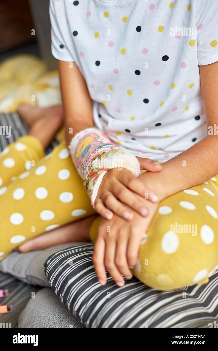 Teen girl with a broken arm at home an orthopedic cast, casted arm ...