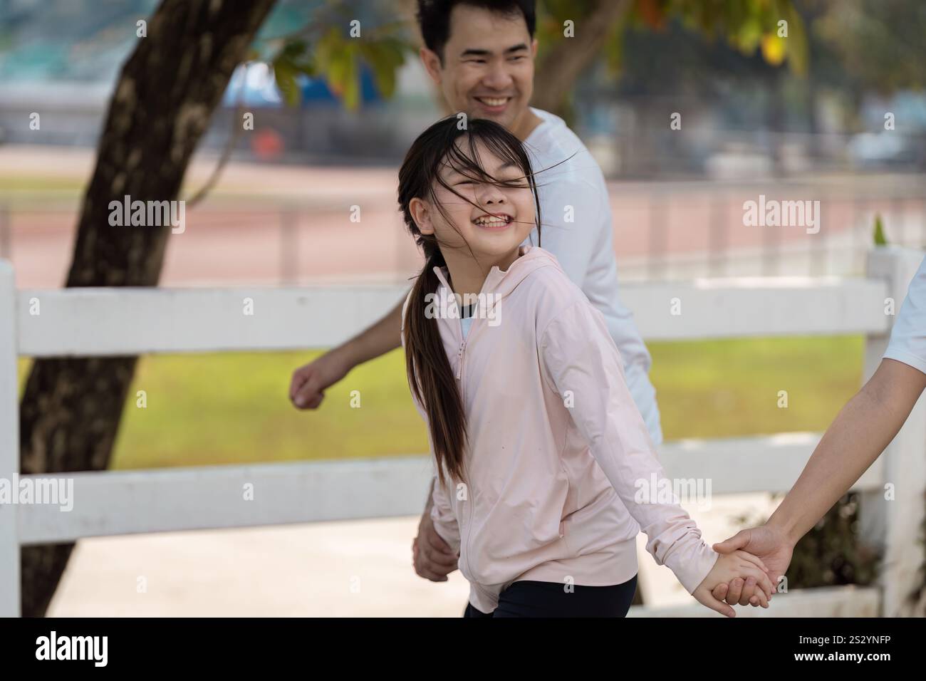 Happy Family Enjoying Outdoor Exercise Together in a Park Setting ...