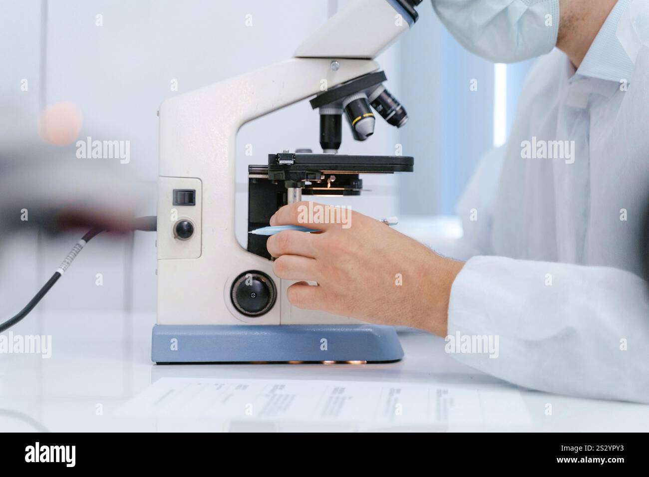 Medical Professional using Microscope Stock Photo - Alamy
