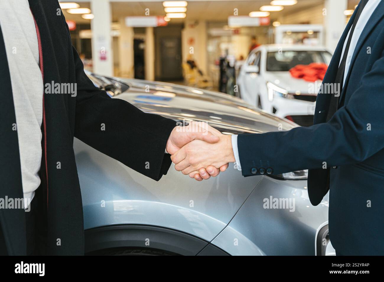 Two men shaking hands during a car sale Stock Photo - Alamy