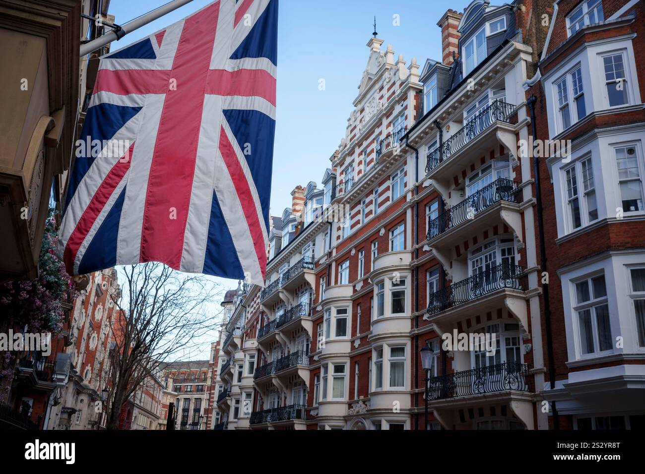 Residential properties and a hanging Union Jack flag on Basil Street in ...