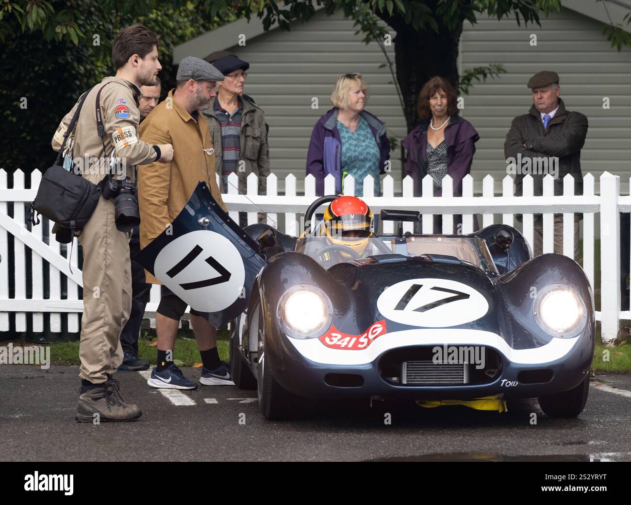 Saif Assam sits in his 1958 Lister-Jaguar "Knobbly" in the paddock ...