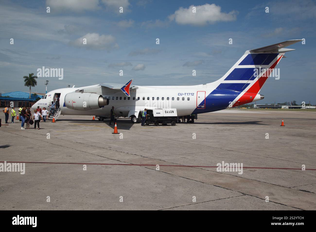 Passengers exiting an Antonov-158 jet airplane of Cubana airlines ...