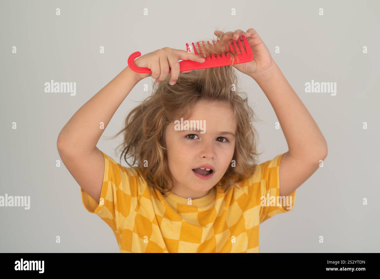 Kid combing hair after shower. Little child boy combing hair, isolated ...