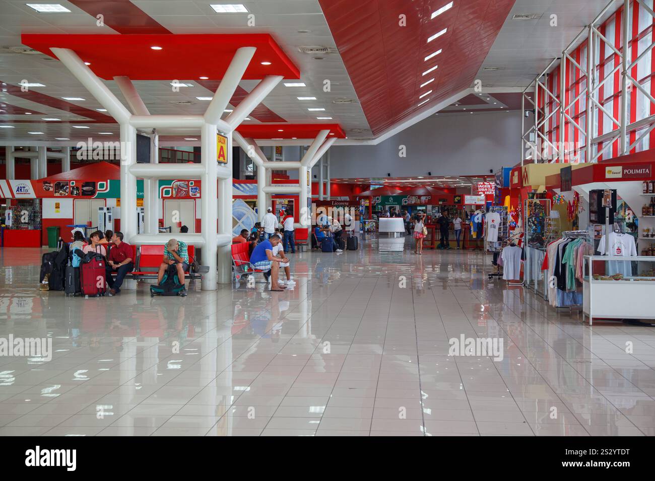 Passengers at the red and white check-in area of the Jose Marti ...