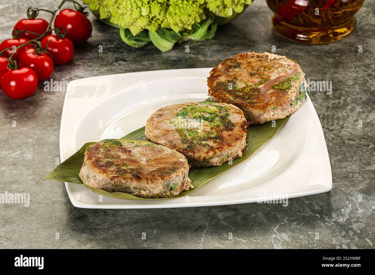 Roasted tuna medallion with broccoli cabbage Stock Photo - Alamy