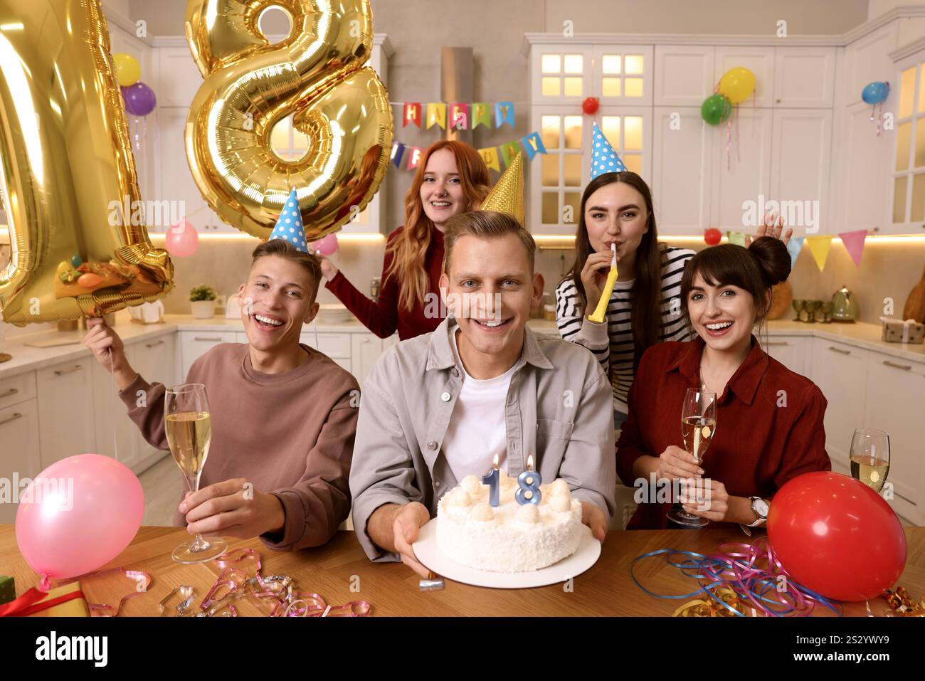 18th birthday. Group of friends with tasty cake having coming of age ...