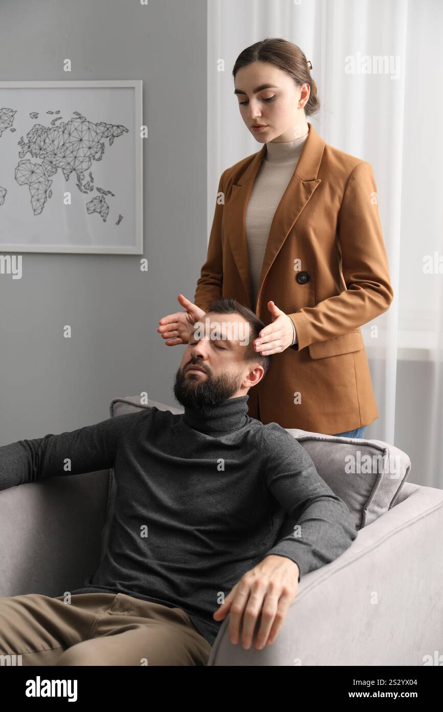 Psychologist working with patient during hypnosis session indoors Stock ...
