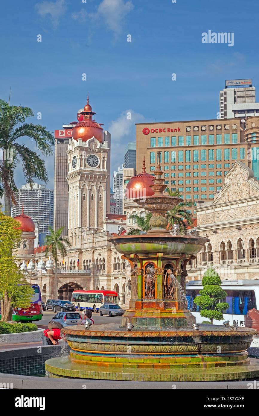 Historic clock tower and fountain in central Kuala Lumpur during ...