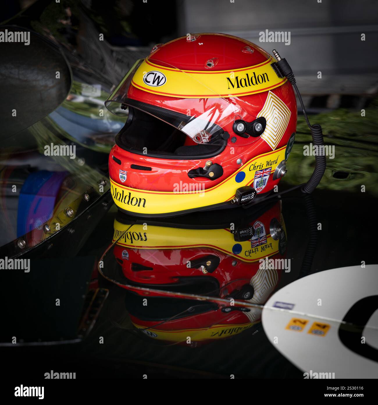 Chris Ward's red and yellow racing crash helmet with reflection in the ...