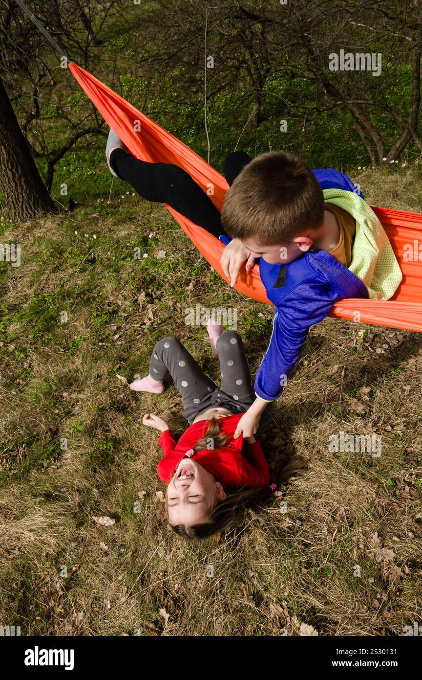 Two children, a boy and a girl, enjoy a fun-filled day outdoors. The ...