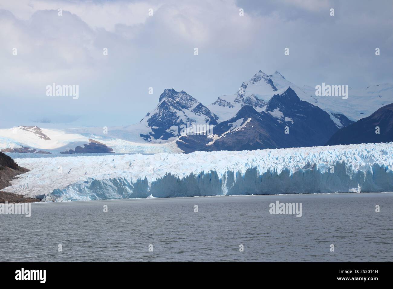 Perito Moreno in front of snow covered mountains Stock Photo - Alamy
