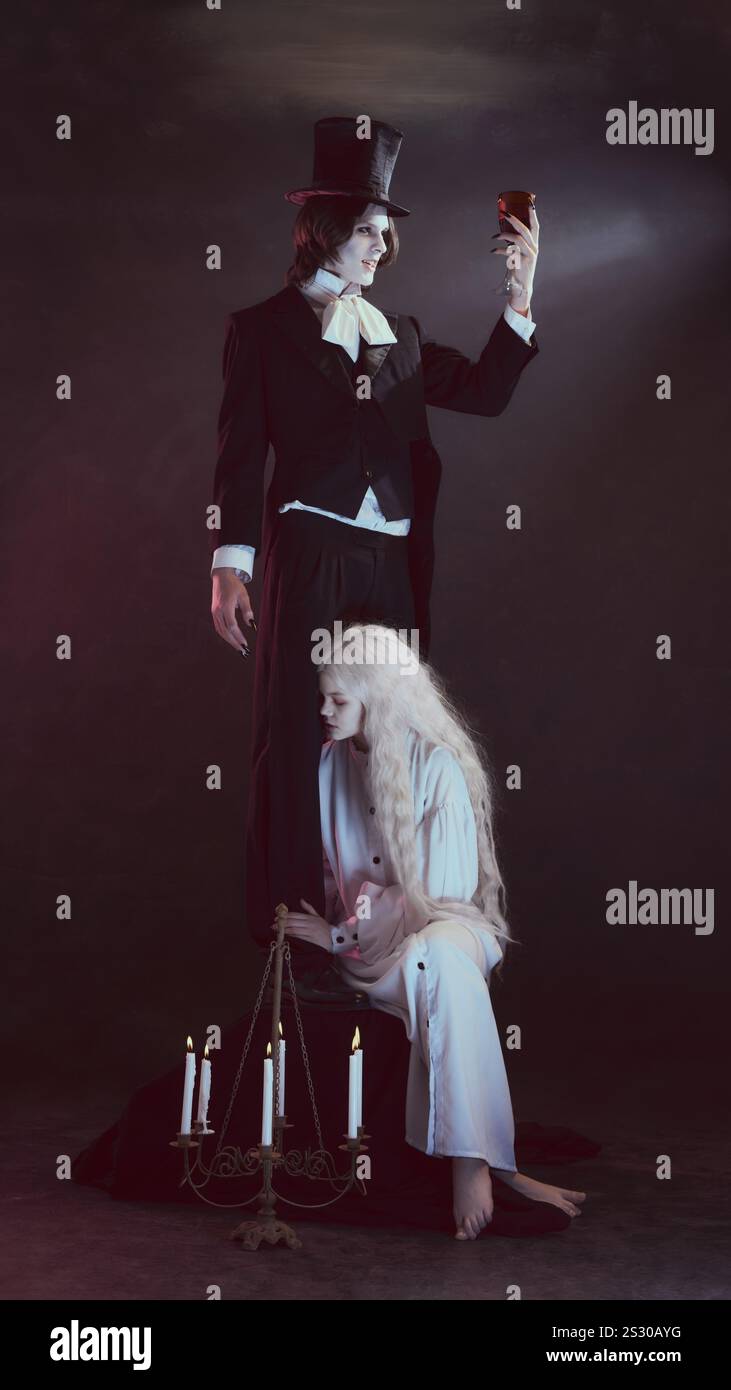 Vampire in suit raises wine glass, levitating over woman in white gown ...
