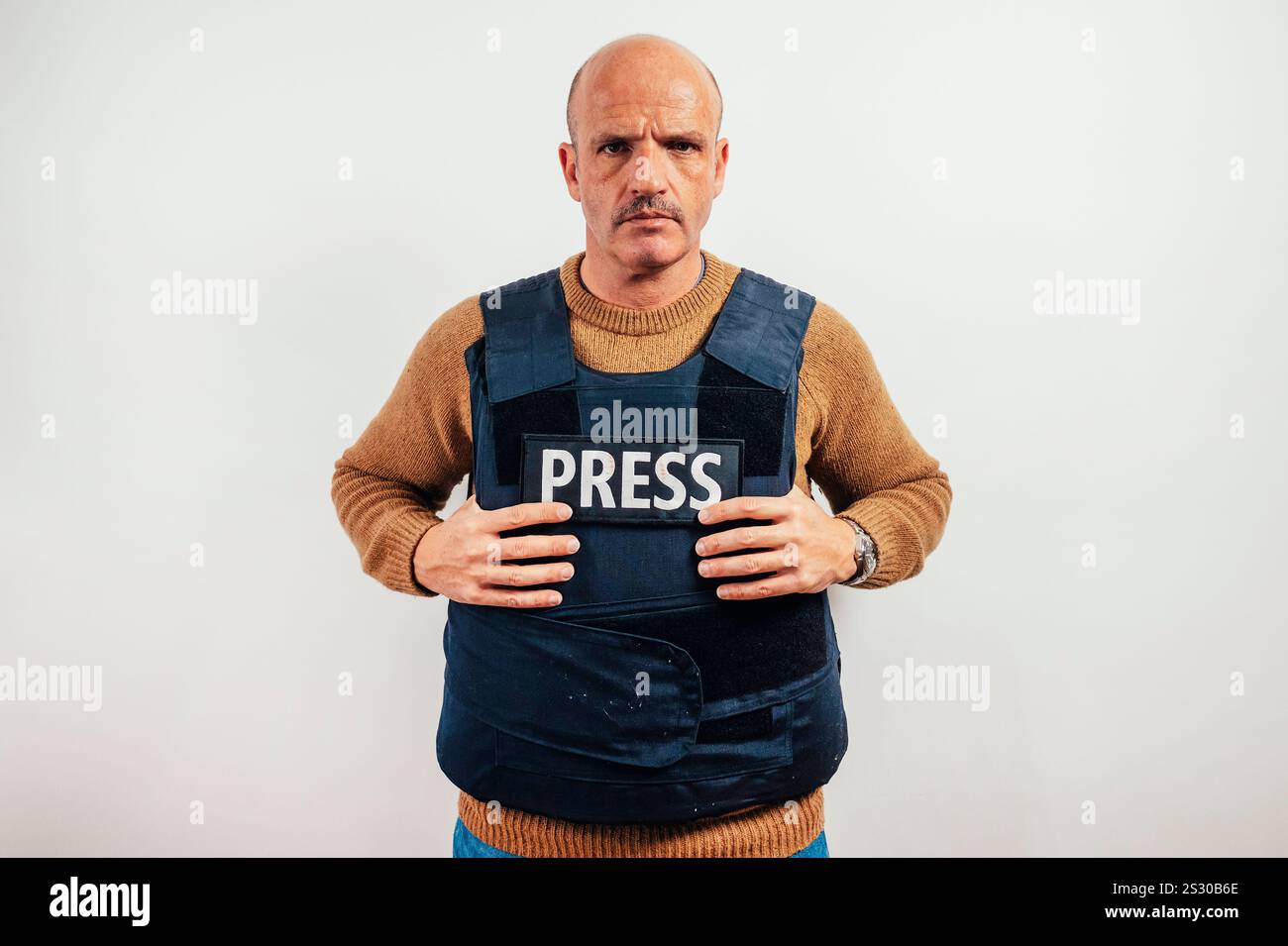 Reporter with bulletproof vest on white background Stock Photo - Alamy