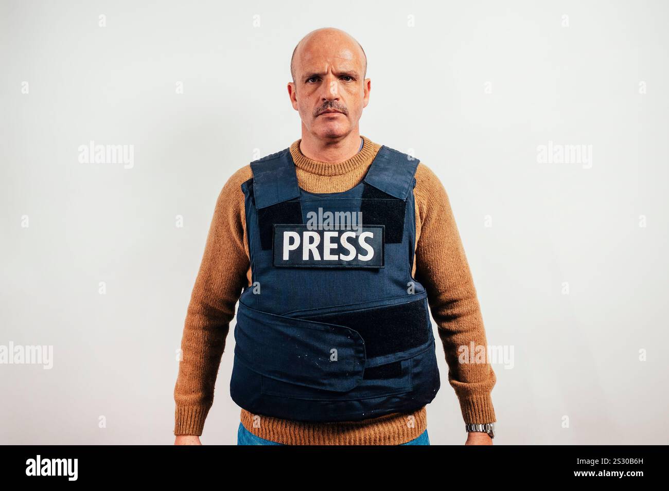 Reporter with bulletproof vest on white background Stock Photo - Alamy