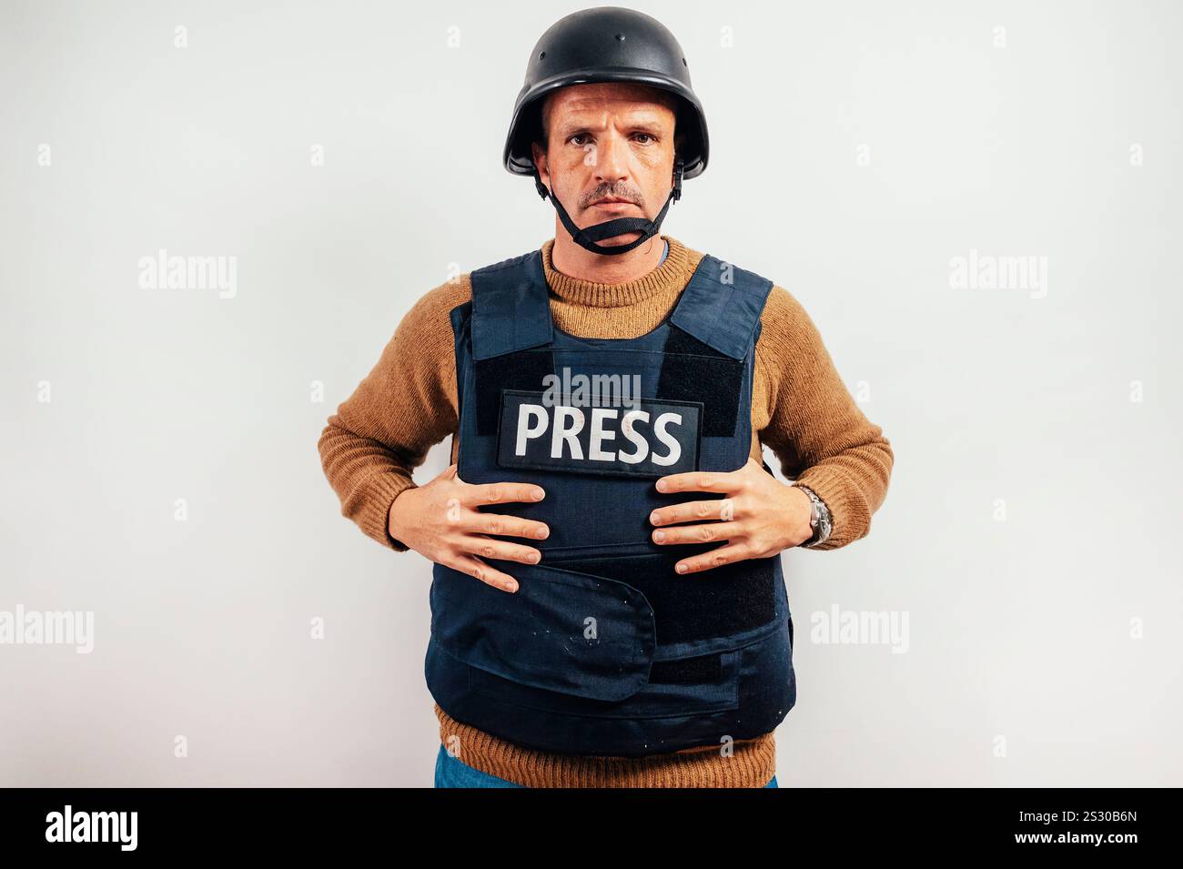 Reporter with bulletproof vest on white background Stock Photo - Alamy