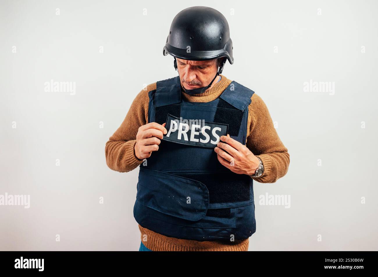 Reporter with bulletproof vest on white background Stock Photo - Alamy