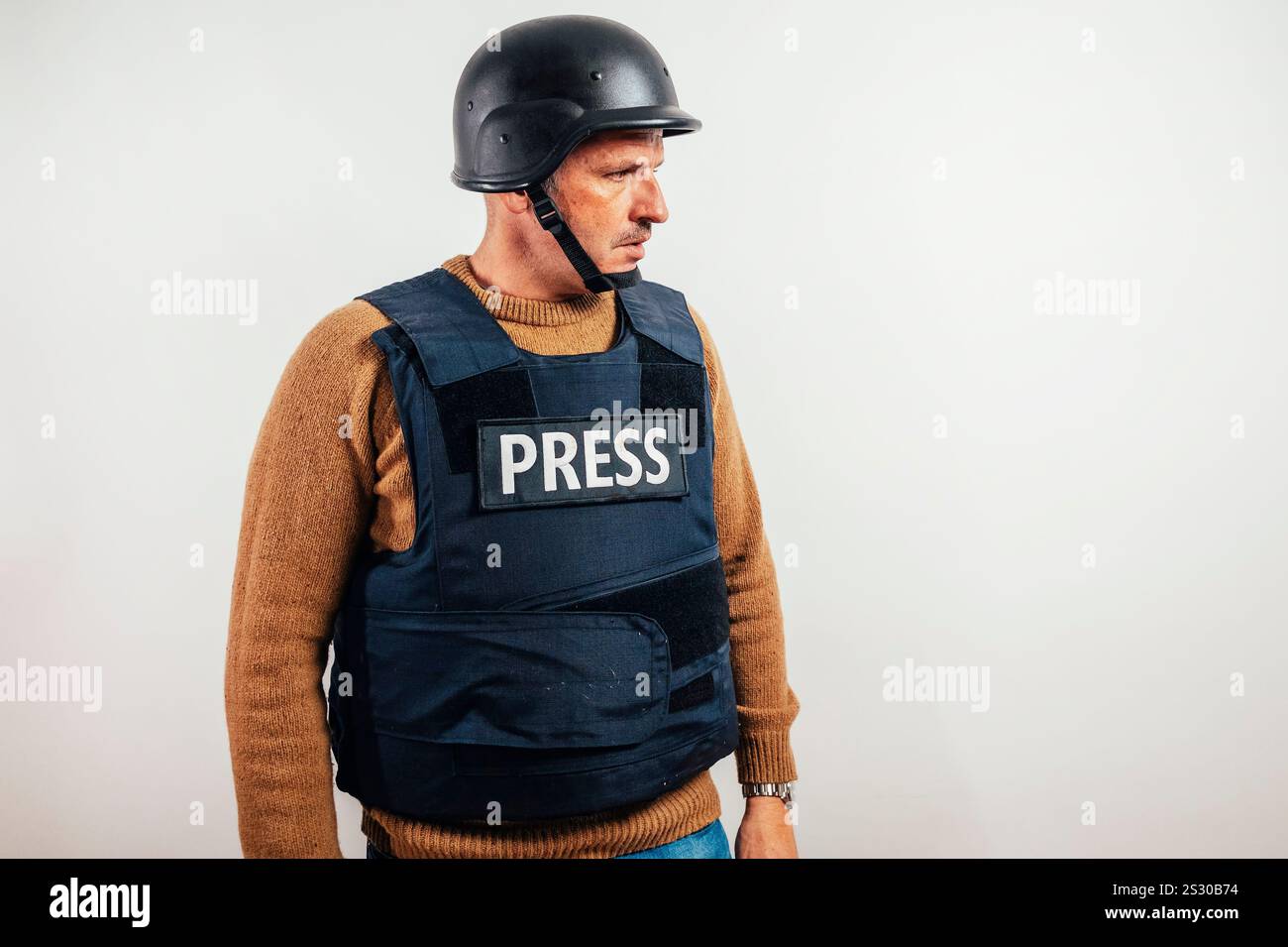 Reporter with bulletproof vest on white background Stock Photo - Alamy