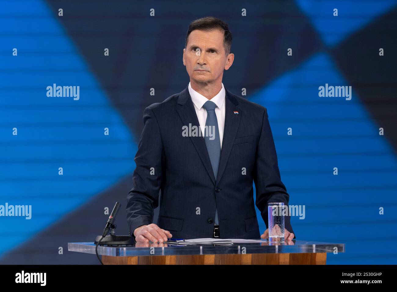 Croatian Presidential candidate Dragan Primorac looks at his opponent ...