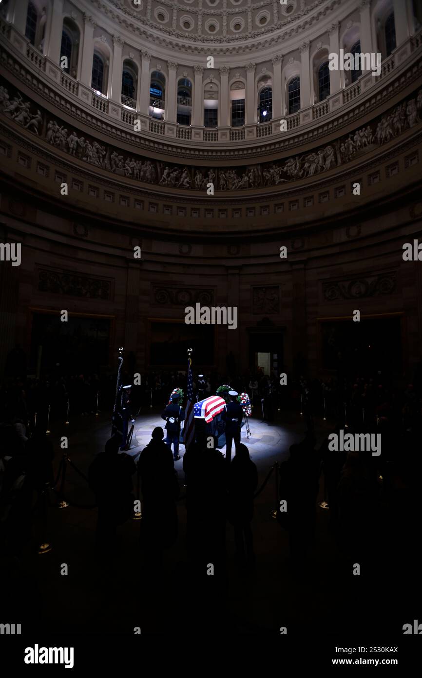 A spotlight iluminates the flag draped casket to pay tribute to the ...