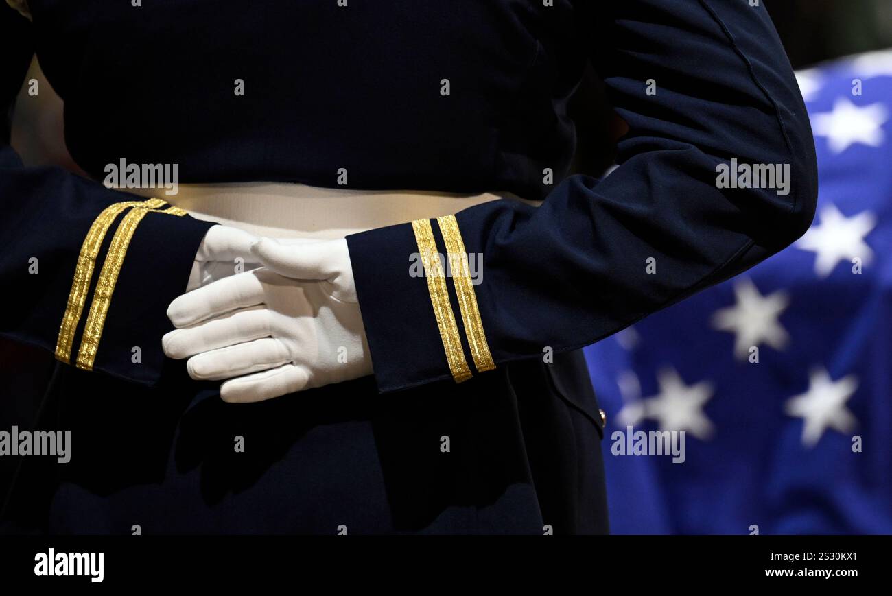 A member of he Military Honor Guard stands before the flag draped ...
