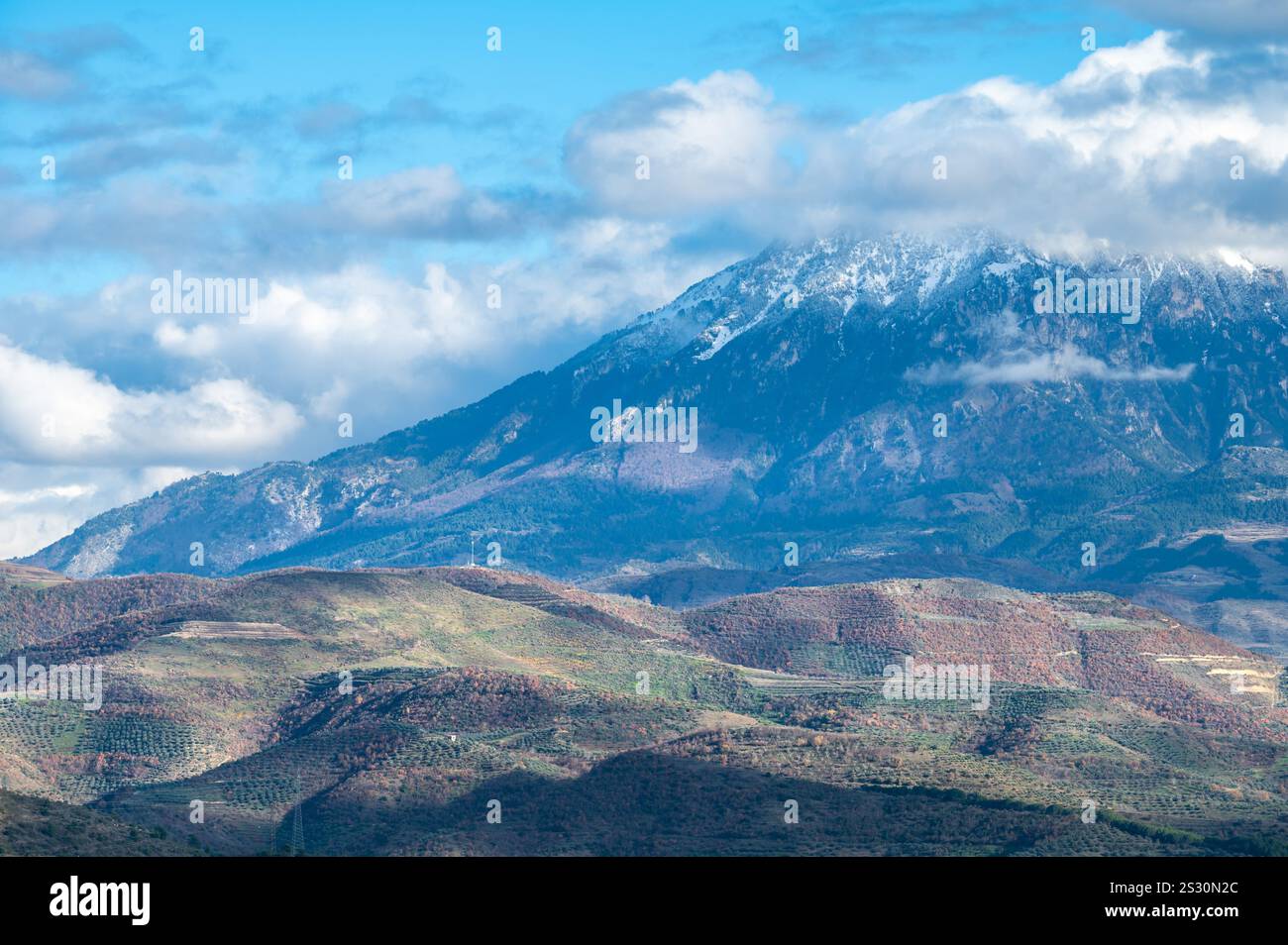 Snow topped mountains with fog and green hills around Berat, Albania ...