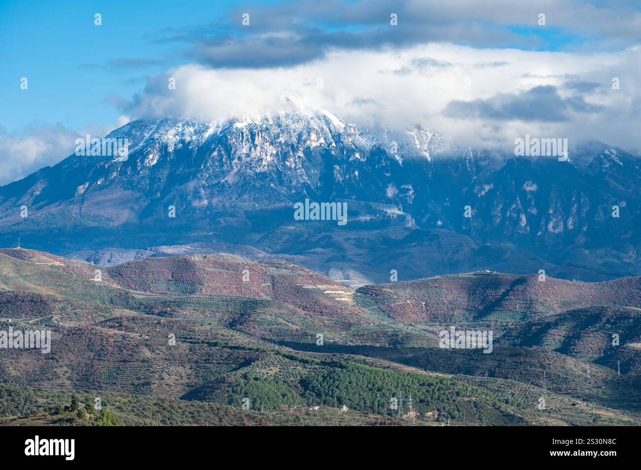 Snow topped mountains with fog and green hills around Berat, Albania ...
