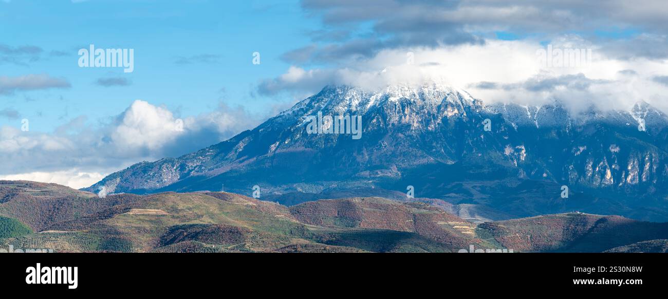 Snow topped mountains with fog and green hills around Berat, Albania ...
