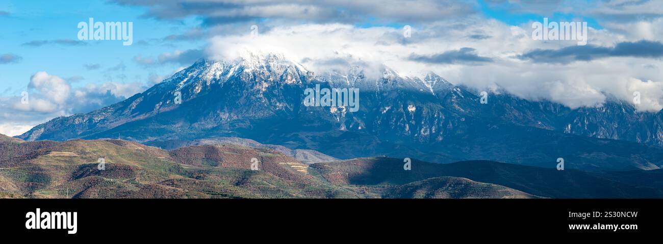 Snow topped mountains with fog and green hills around Berat, Albania ...