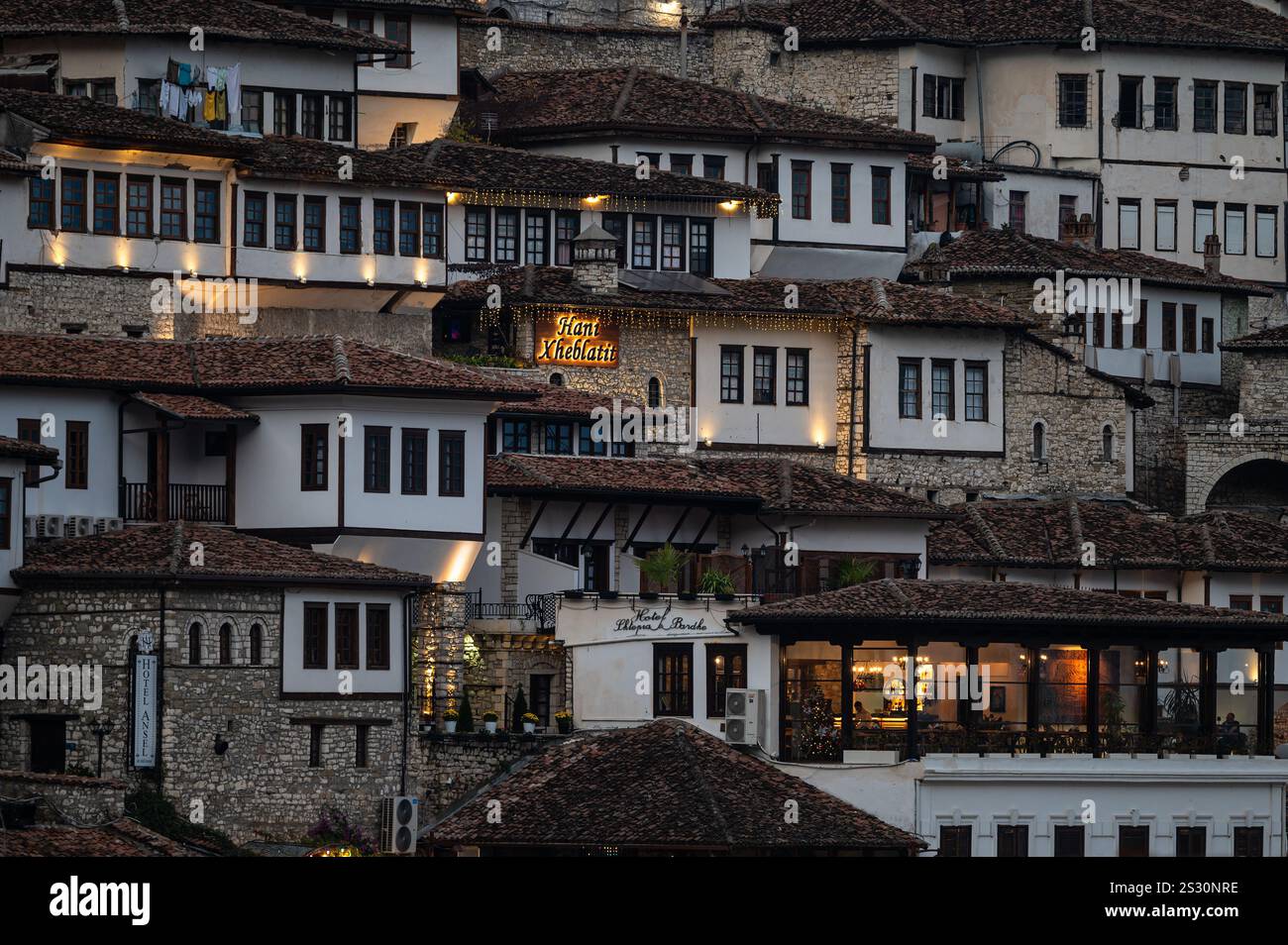Traditional house facades on the hills of the village of Berat, Albania ...