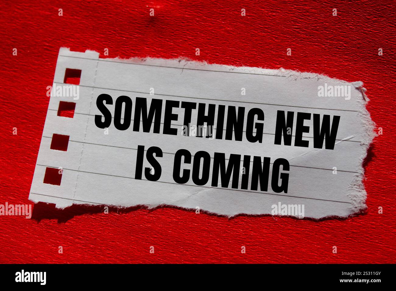 Something new is coming message written on ripped torn paper piece with ...