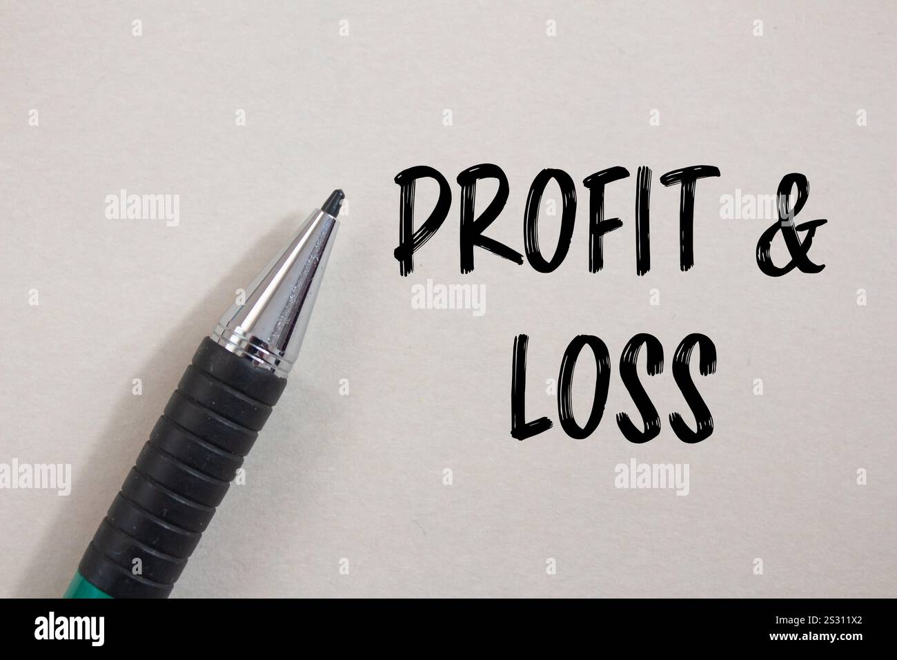 Profit and loss message written on white paper with a pen. Conceptual ...