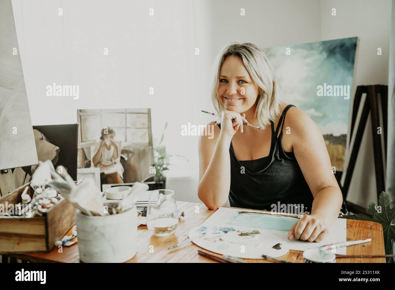 Happy, painting and portrait of woman in studio at desk for drawing ...