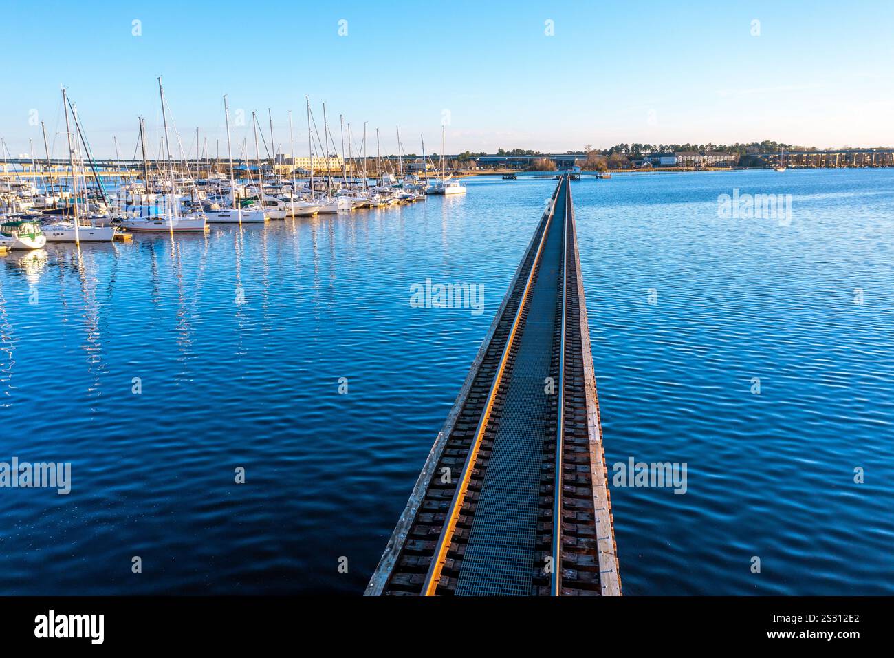 Aerial View of a railroad bridge over water next to a marina in New ...