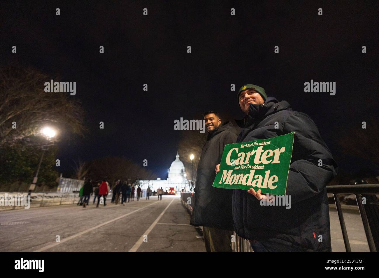UNITED STATES - JANUARY 7: A man holds a Carter Mondale campaign sign ...